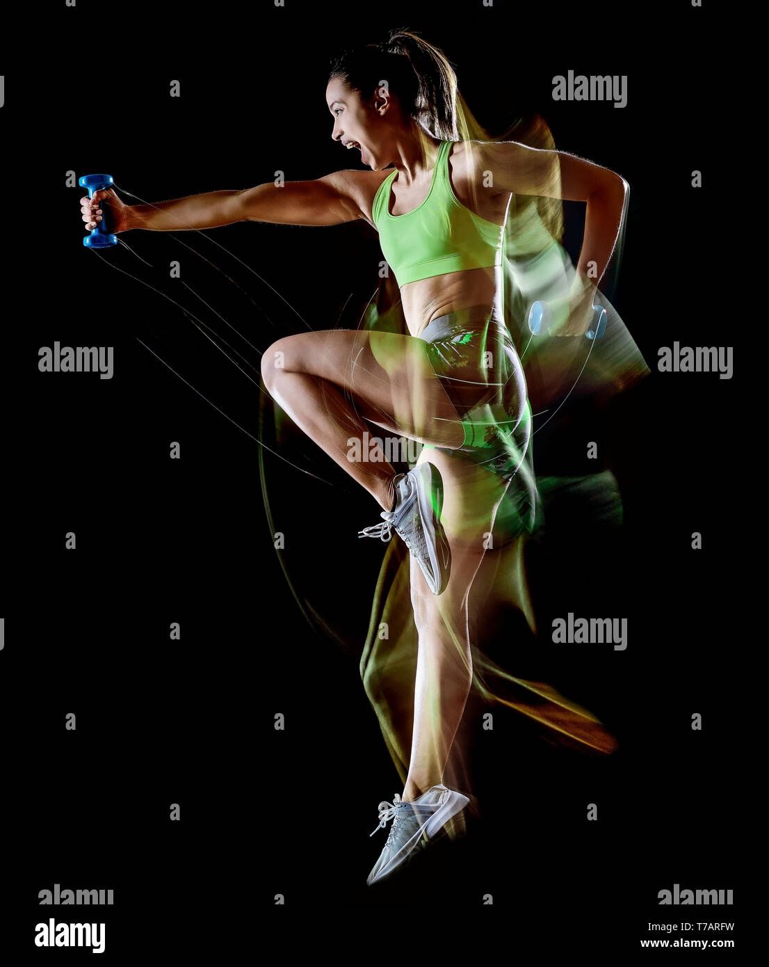 one mixed race woman exercising fitness exercises isolated on black ...