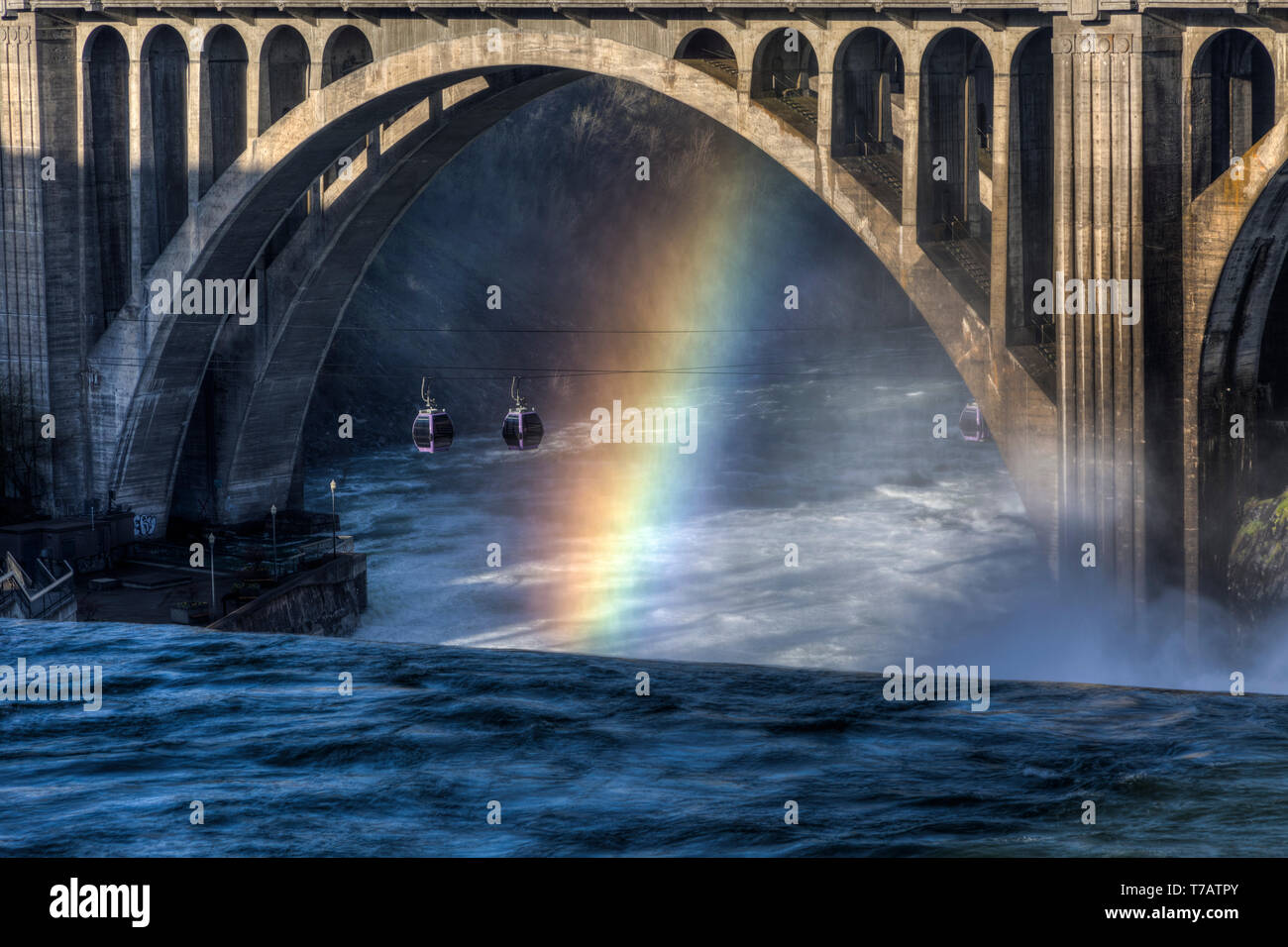 A rainbow appears over Spokane Falls with the Monroe street bridge in ...