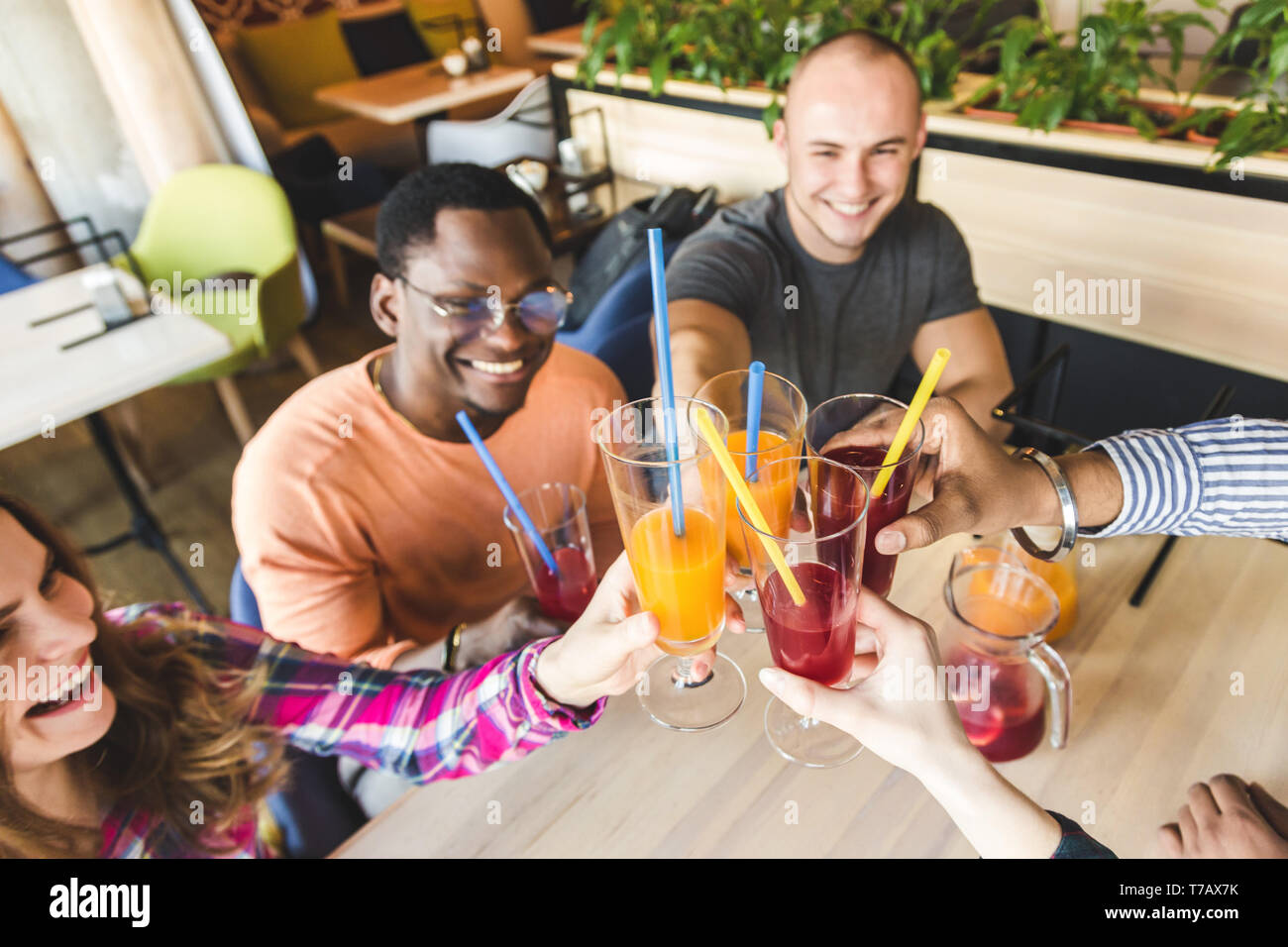 Company of young people having fun, drinking drinks, cocktails, juices ...