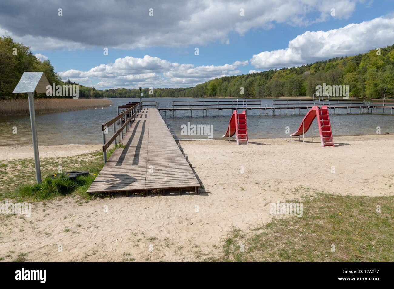 Empty swimming pool in Central Europe. Wooden jetty on the lake. Season ...