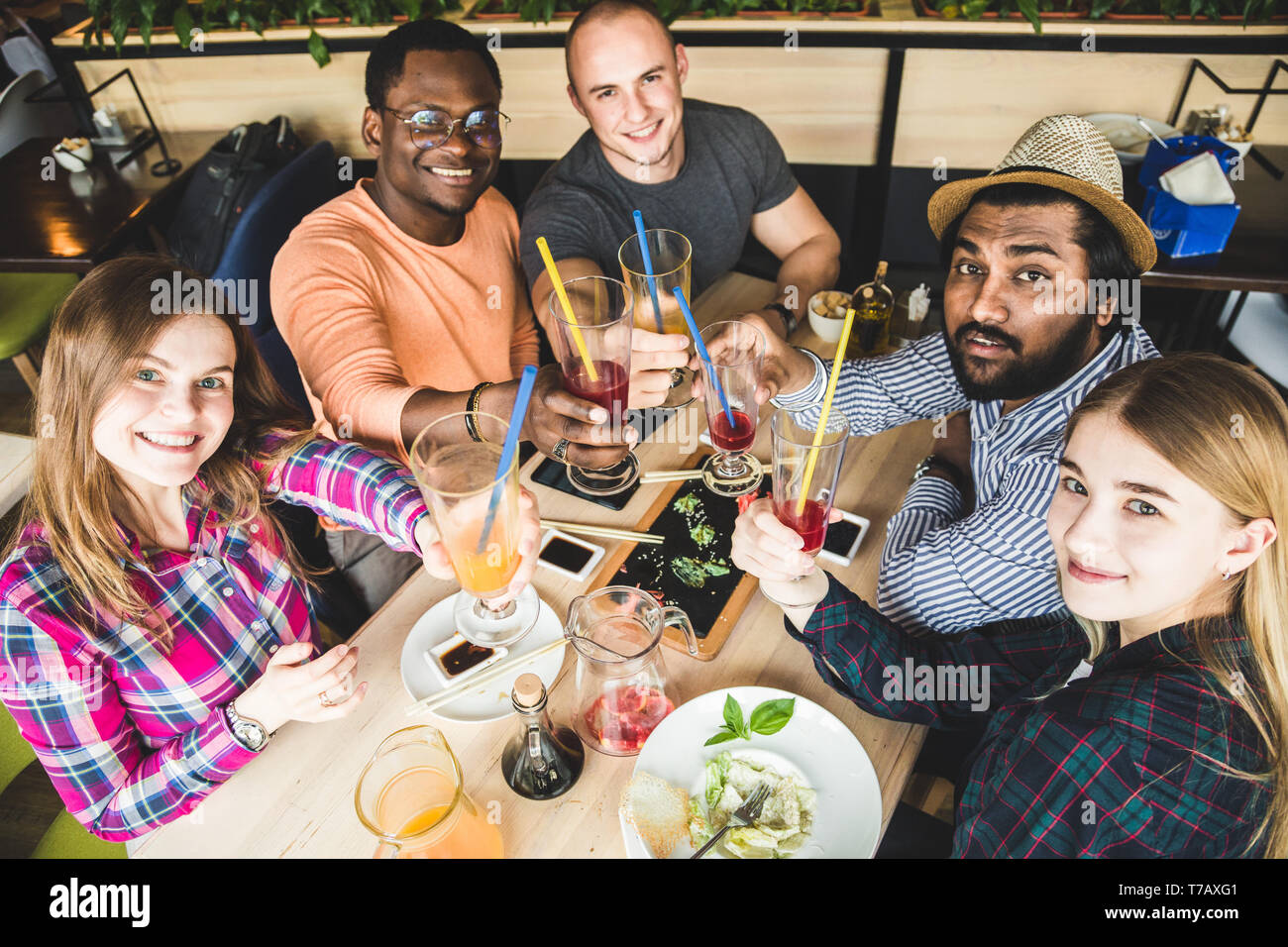 Meet young attractive people in the cafe. Friends chat, have fun, drink ...