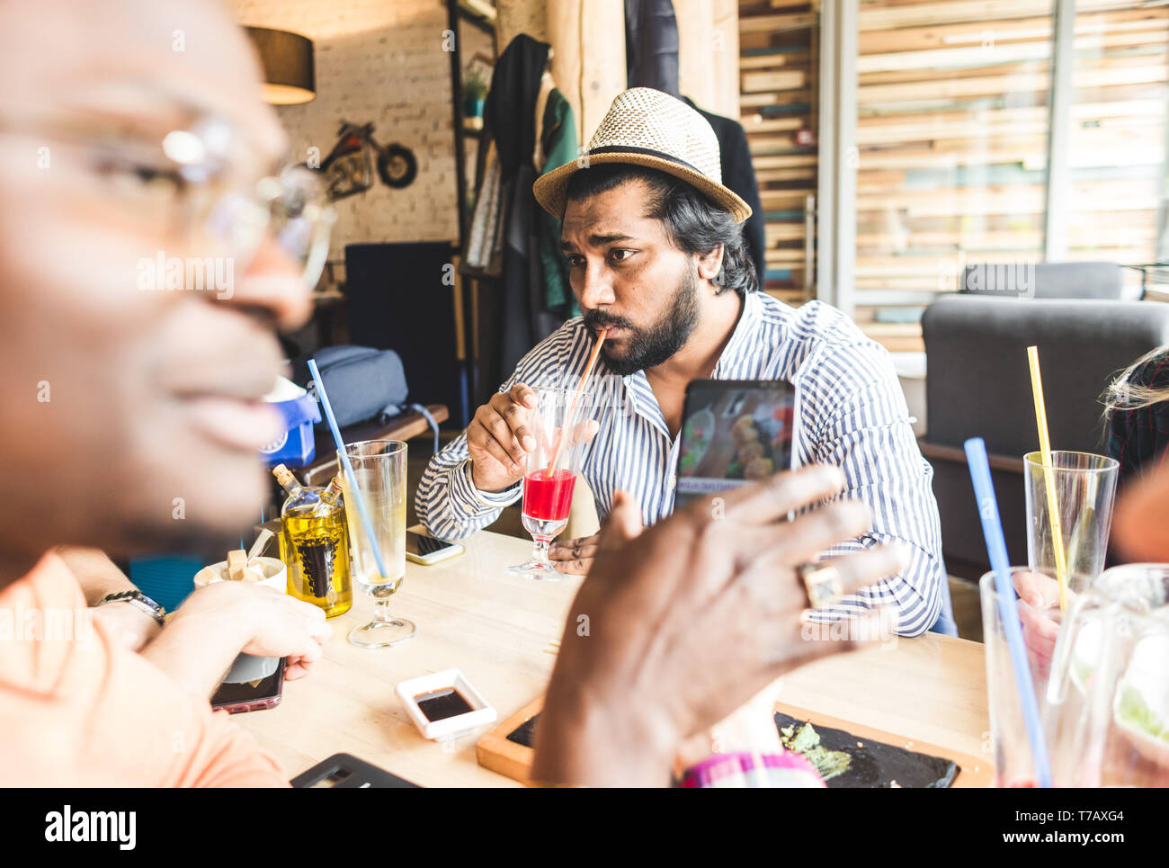 Meet young attractive people in the cafe. Friends chat, have fun, drink ...