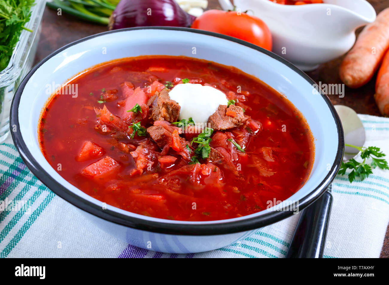 Borsch is a traditional Ukrainian dish in a bowl and products for its ...