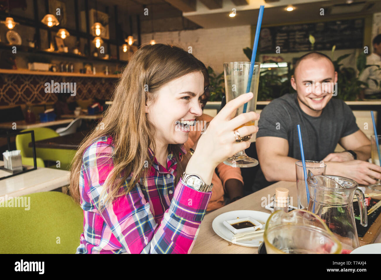 Meet young attractive people in the cafe. Friends chat, have fun, drink ...