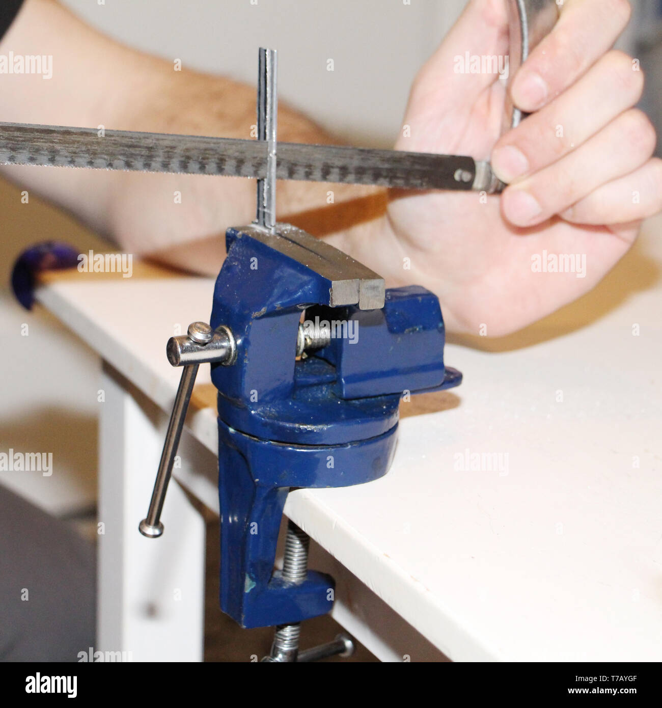 Vice metalwork with the rotary mechanism. Work at home. Hand on the ...