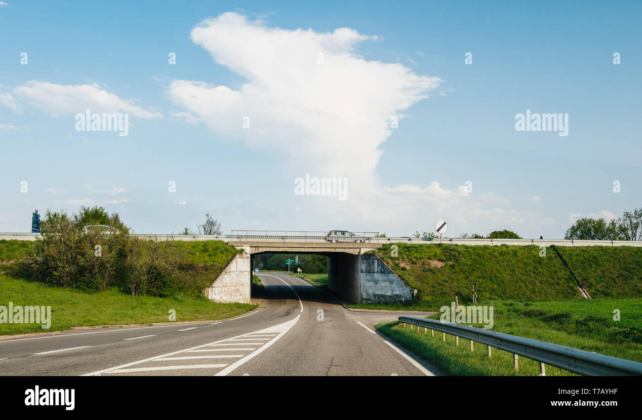 Driver POV at the passage tunnel under French highway with cars driving ...