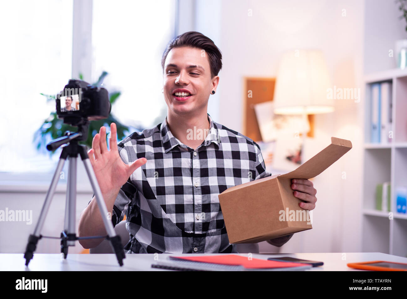 Smiling guy enjoying creation of video content Stock Photo - Alamy
