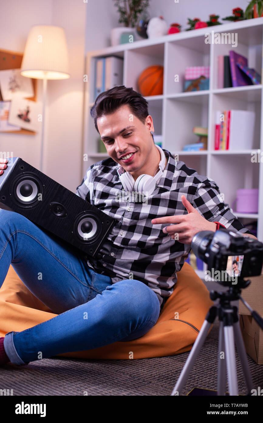 Positive good-looking experienced blogger pointing on spacious speaker ...
