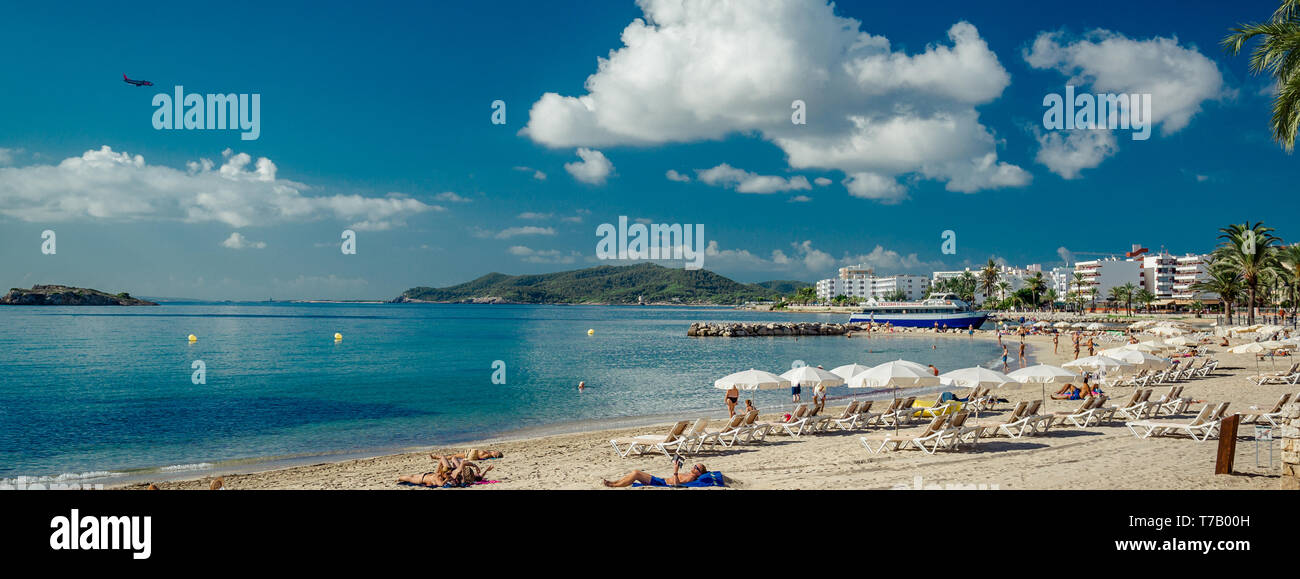 Panoramic image people sunbathing on Ibiza coast, sandy beach. Ibiza ...