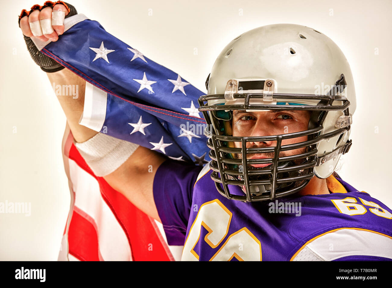 Football Player with uniform and a american flag celebrates victory, on ...