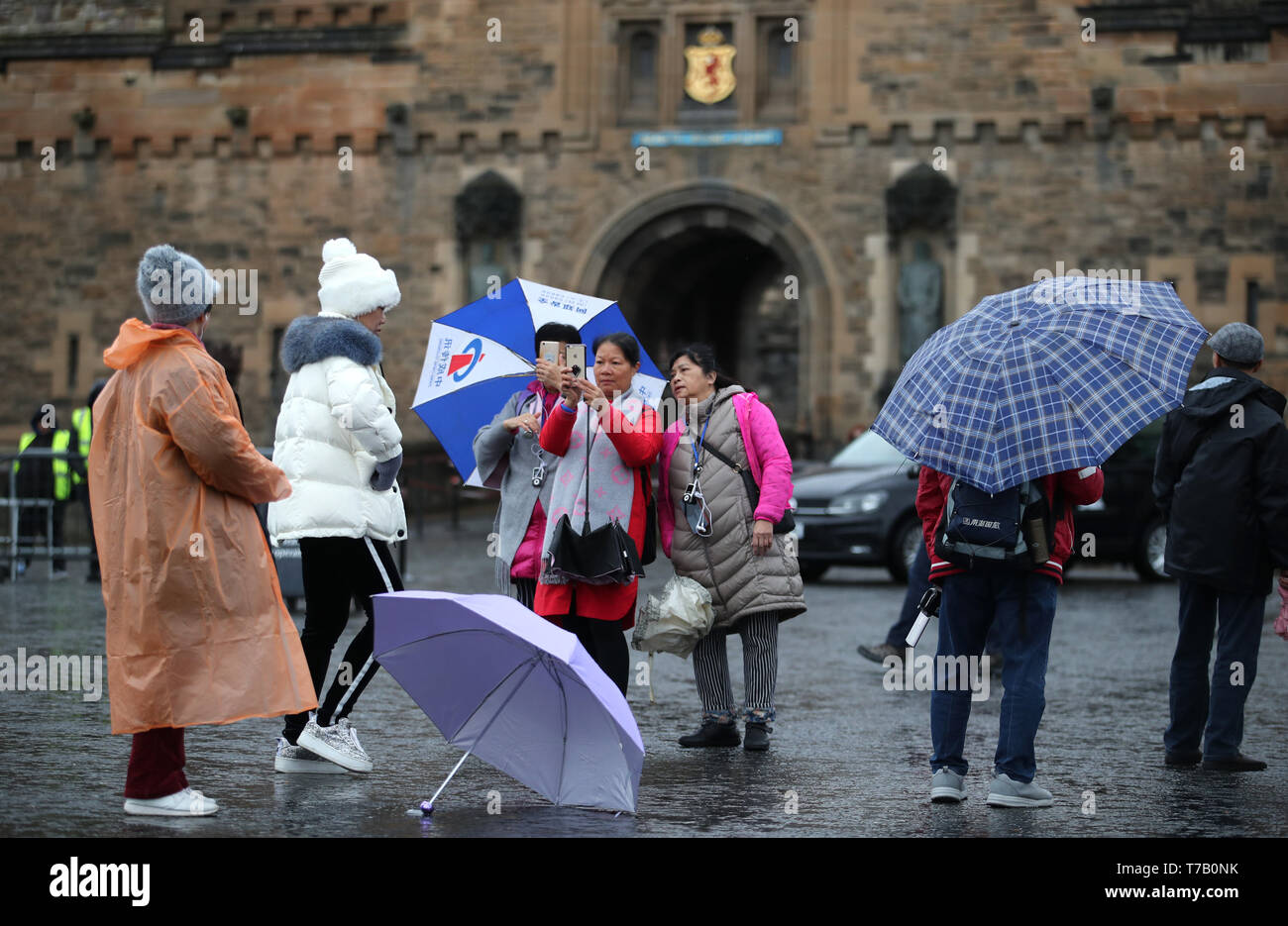 Visitors to Edinburgh Castle brave the cold and the rain on the May ...