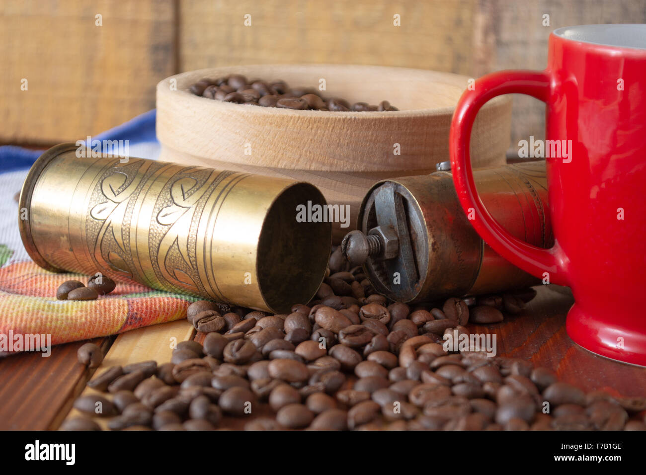 Coffee ready to be milled with old grinder. Coffee is in the table ...