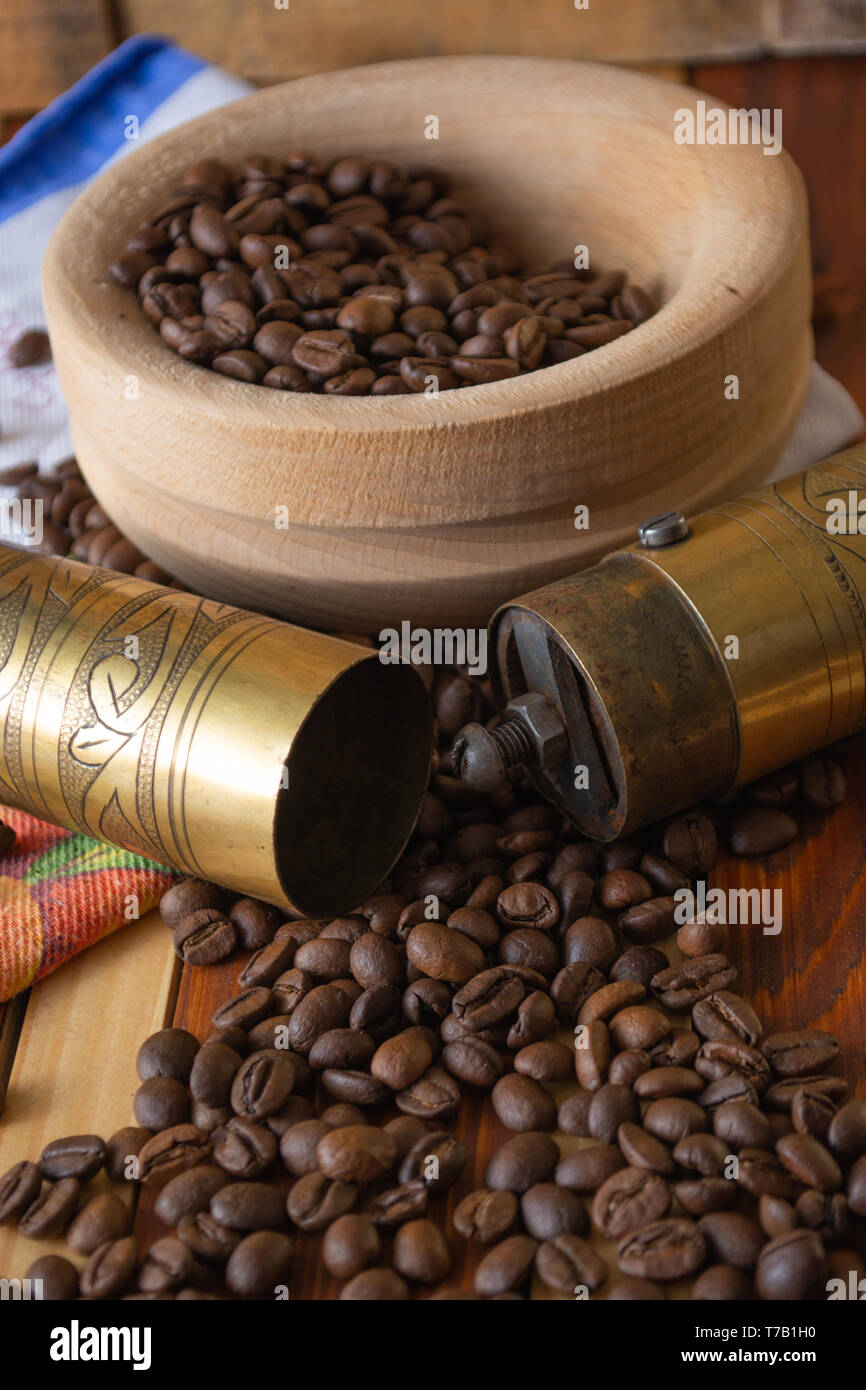 Coffee ready to be milled with old grinder. Coffee is in the table ...