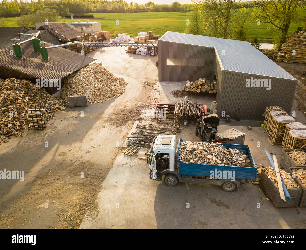 Aerial view of sawmill site with firewood being loaded to truck Stock ...