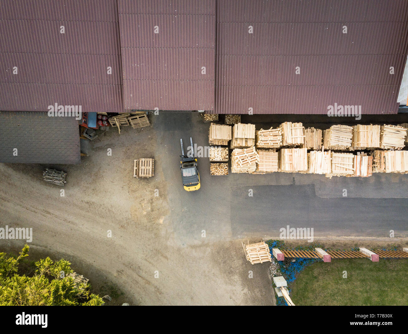 Aerial view of sawmill site during nice spring sunset, wooden pallets ...