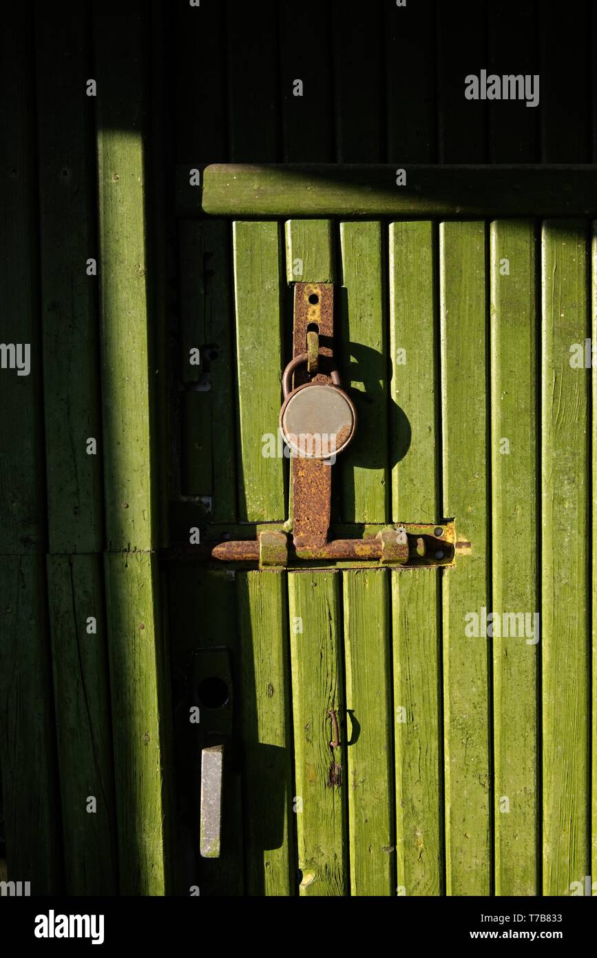 Green wooden door with key lock Stock Photo - Alamy