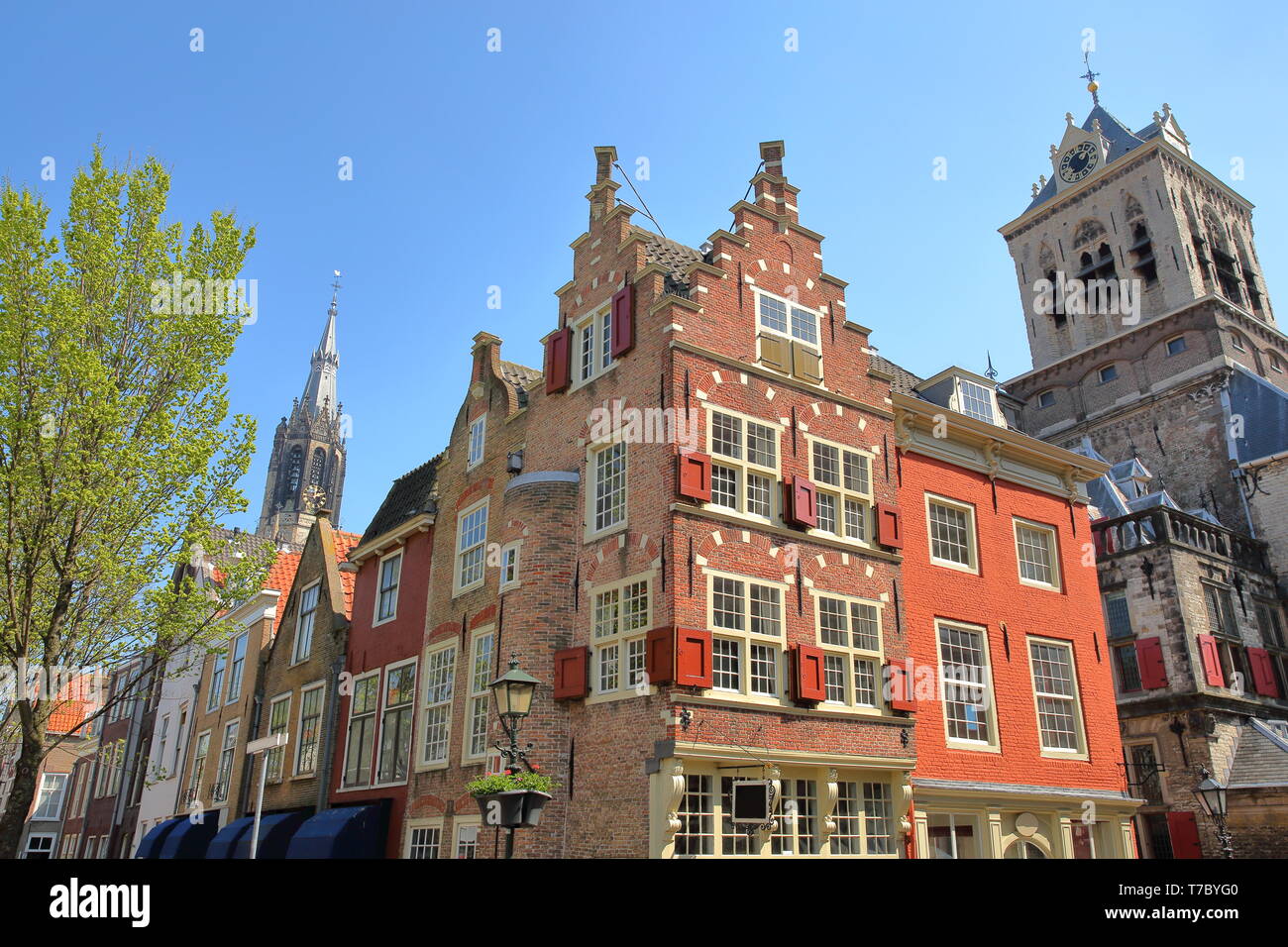 Traditional and colorful facades with Nieuwe Kerk clock tower in the ...