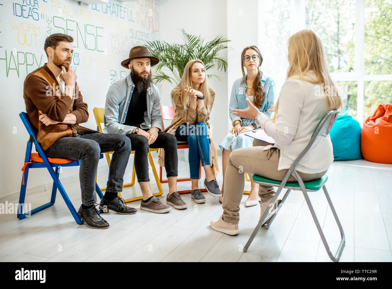 Group of young people sitting together during the psychological therapy ...