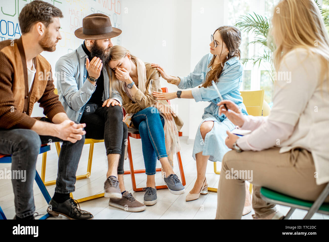Young woman crying during the psychological therapy with group of ...