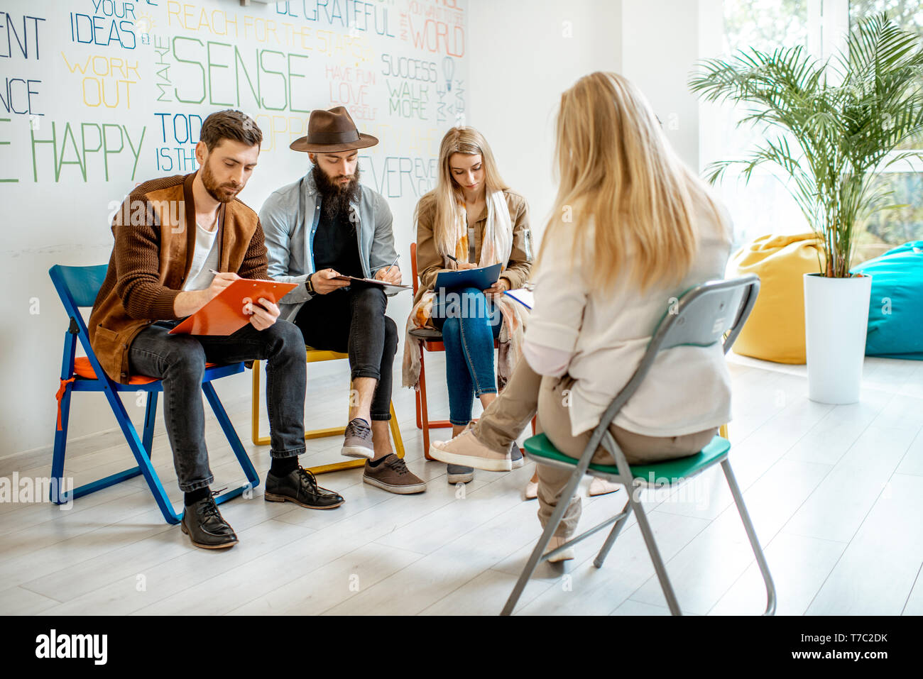 Group of young people sitting together during the psychological therapy ...