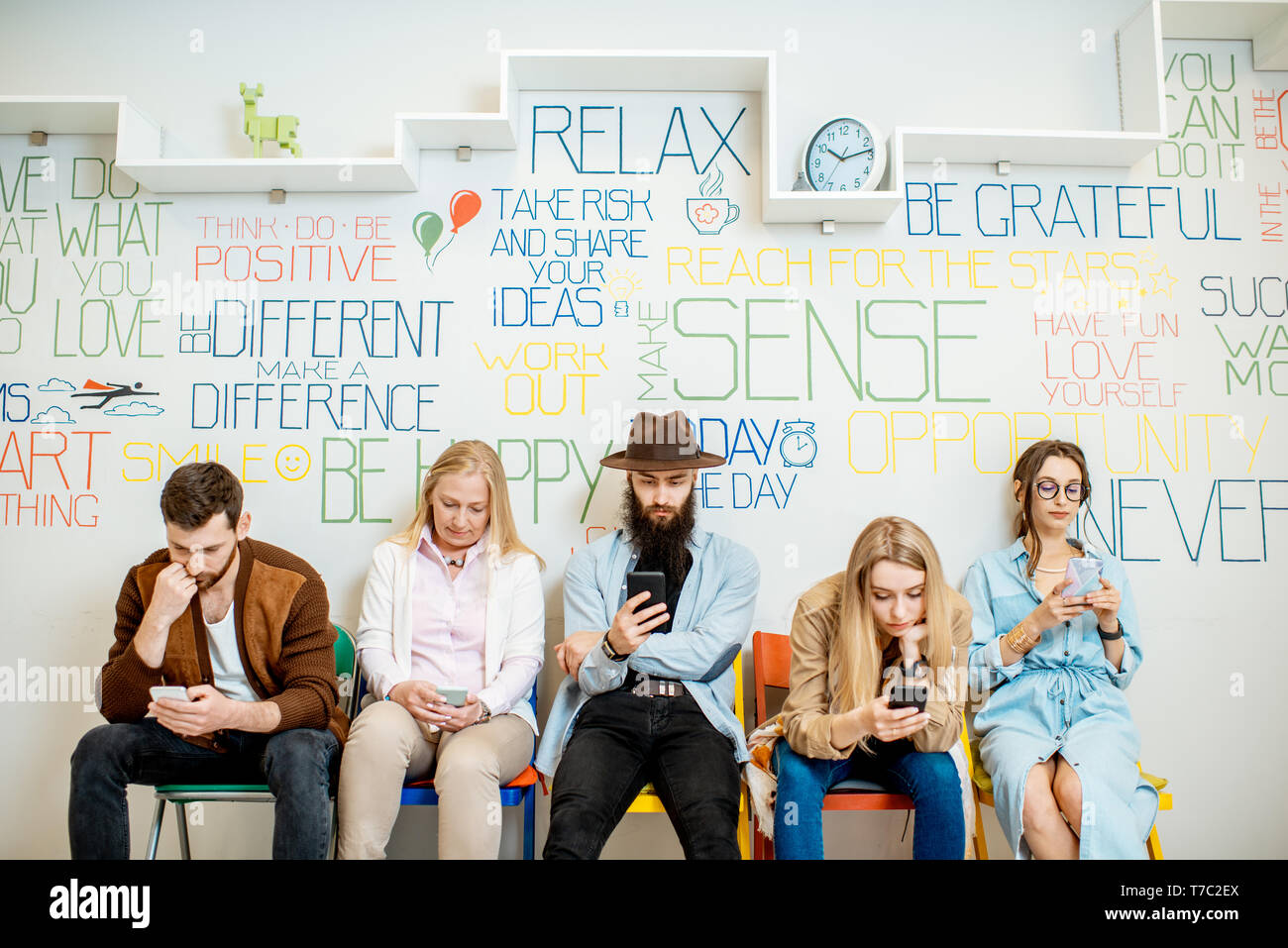 Group Of Diverse People Using Smart Phones While Sitting Together In A