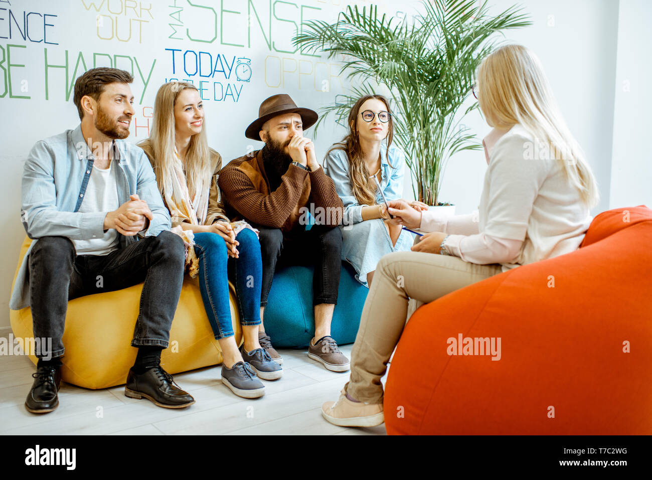 Two young couples sitting during the psychological therapy with ...