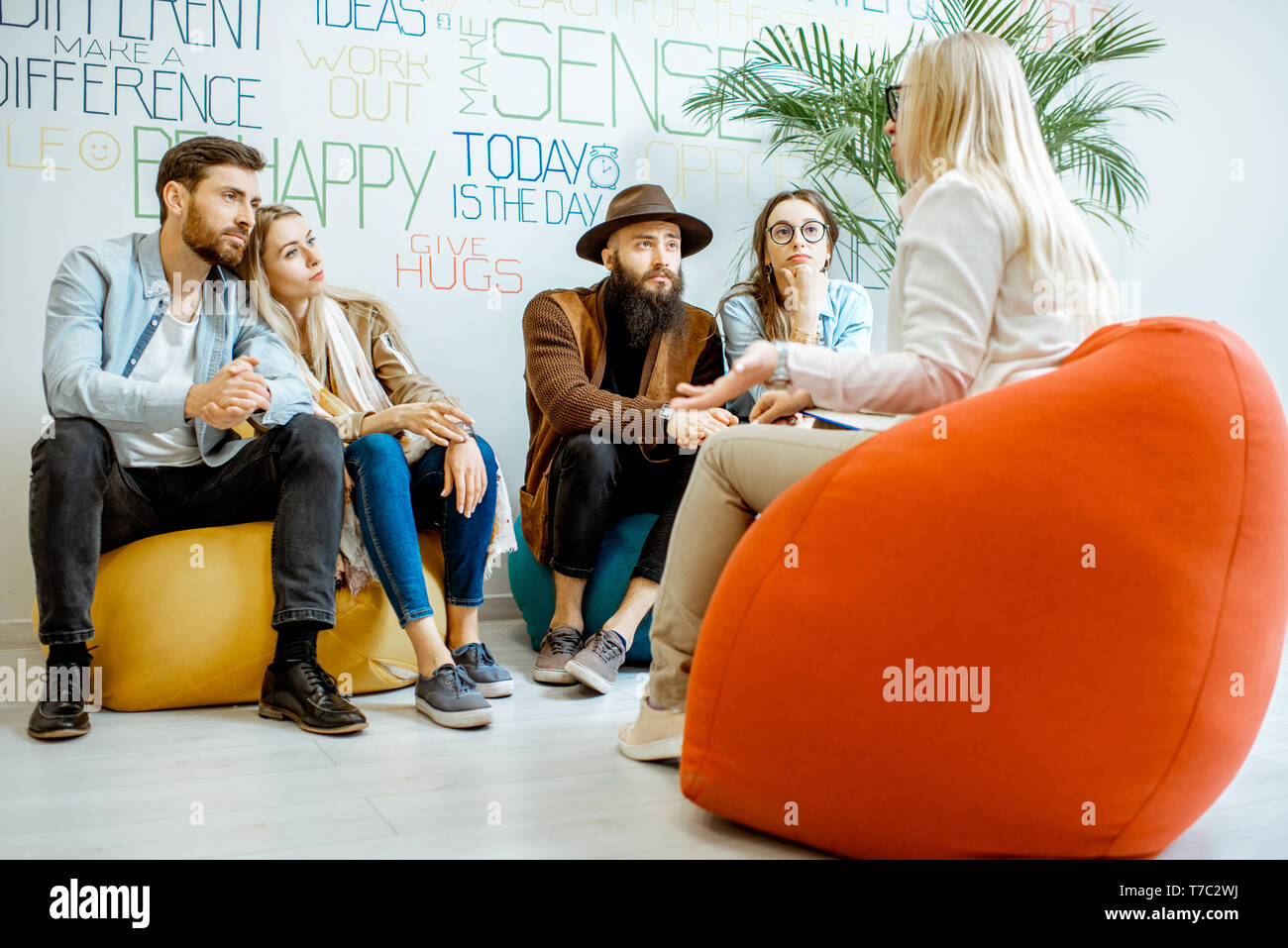 Two young couples sitting during the psychological therapy with ...