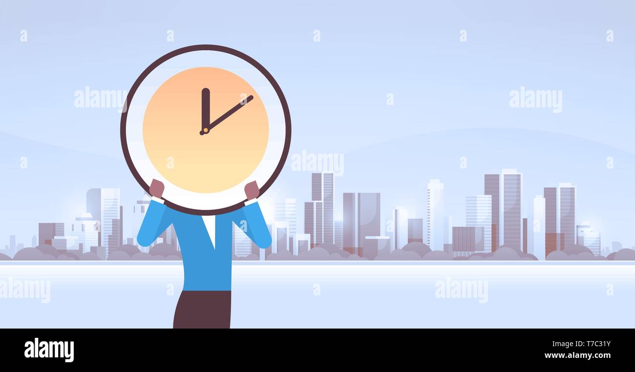 businesswoman holding clock in front of face effective time management ...