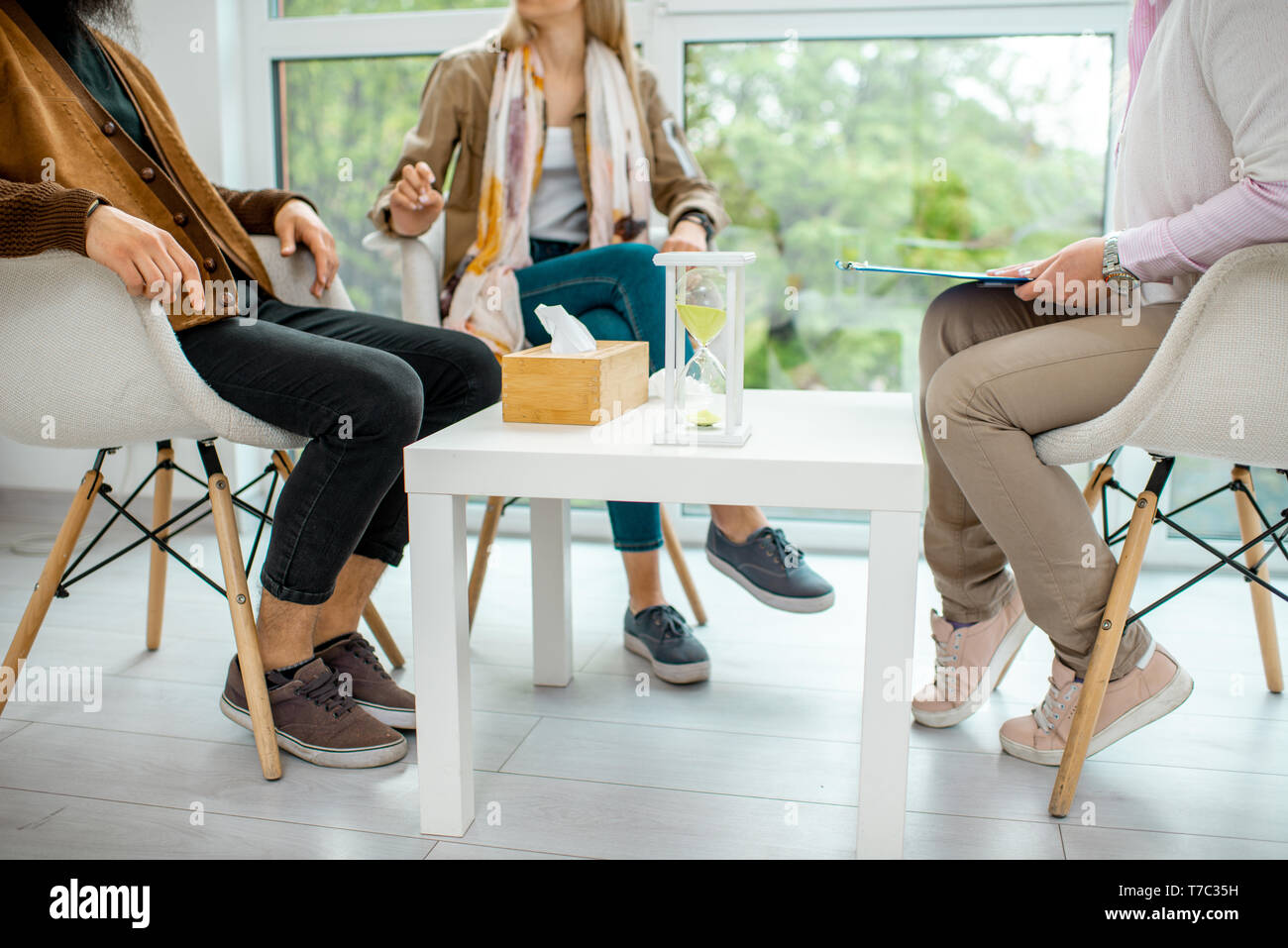 Couple sitting with psychologist during the mental therapy, cropped ...