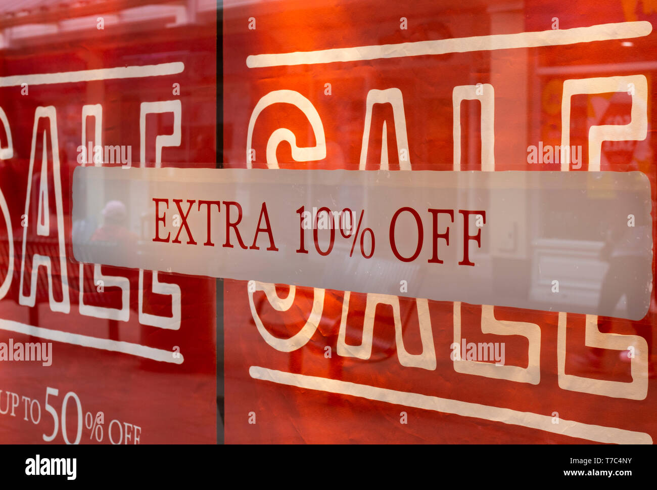 Shop window display with illuminated sale posters with additional 10 ...