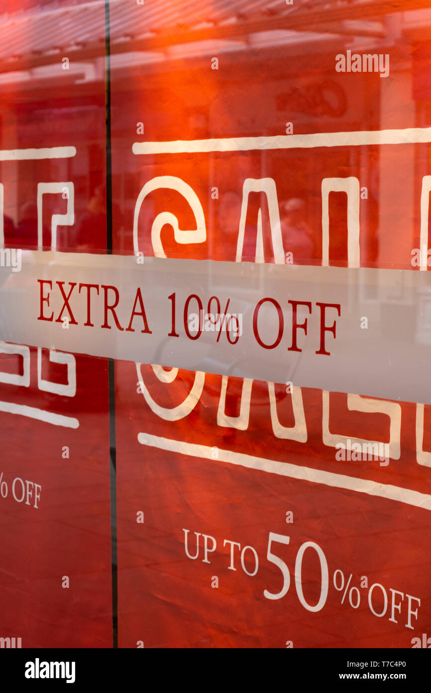 Shop window display with illuminated sale posters with additional 10 ...