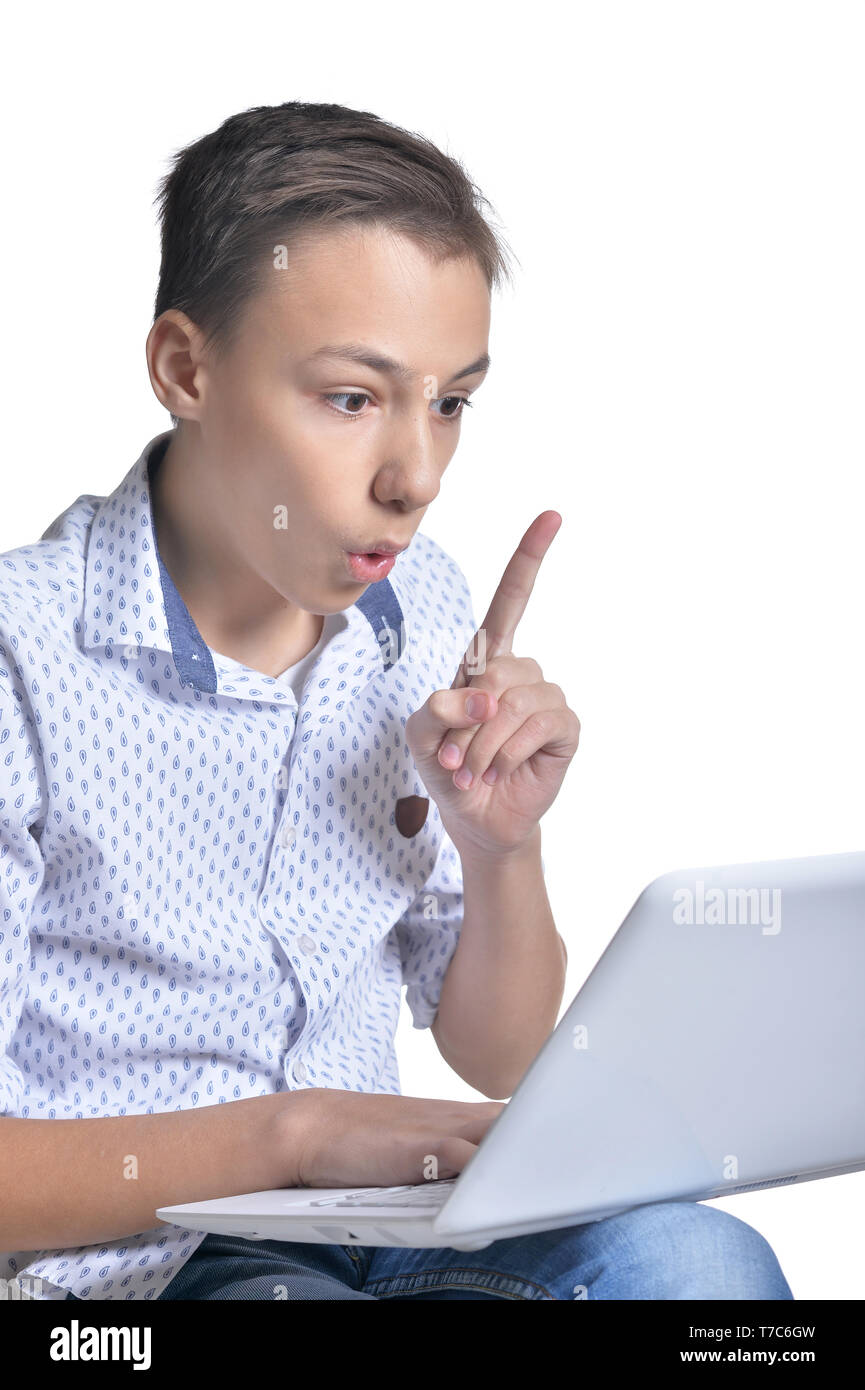 Studio portrait of teenage boy using laptop Stock Photo - Alamy