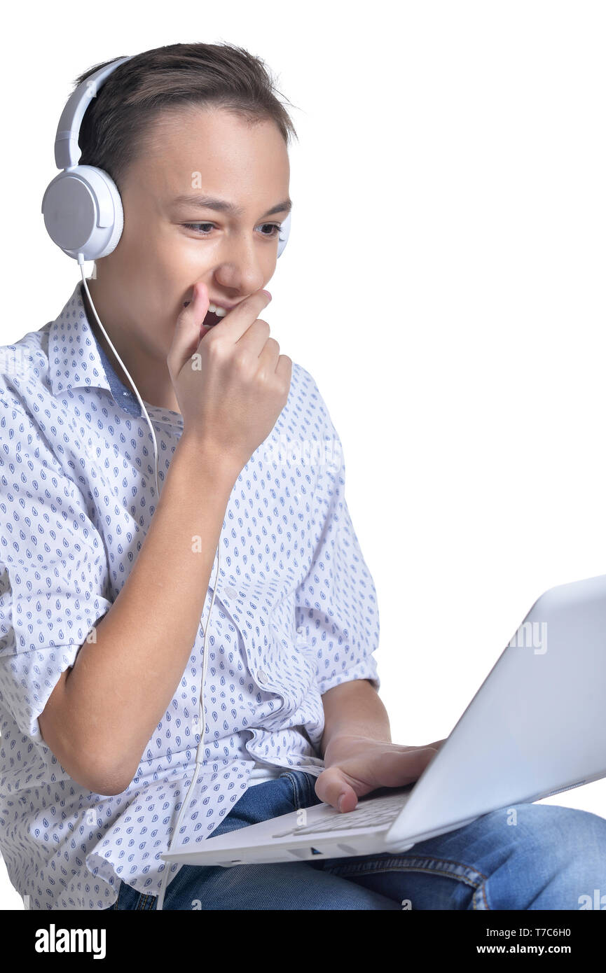 Studio portrait of teenage boy using laptop isolated Stock Photo - Alamy