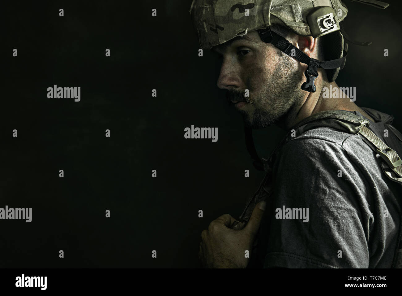 Numb to the feelings. Close up profile portrait of young male soldier ...