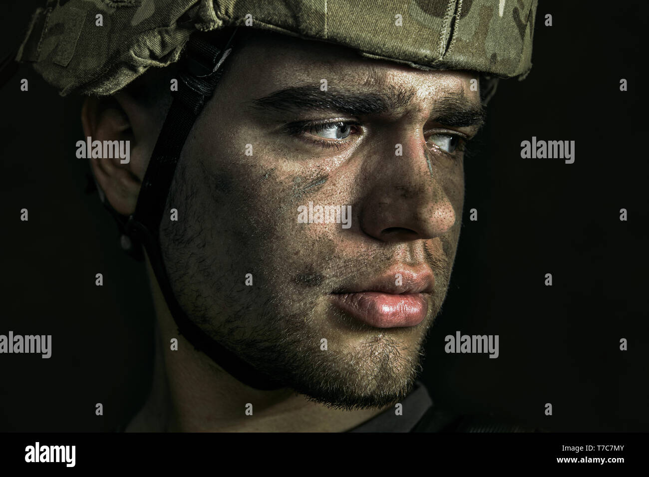Voices of home and peace. Close up portrait of young male soldier. Man ...