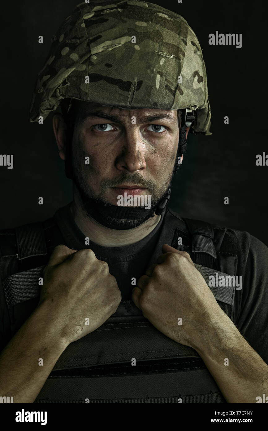 Protecting his family. Close up portrait of young male soldier. Man in ...