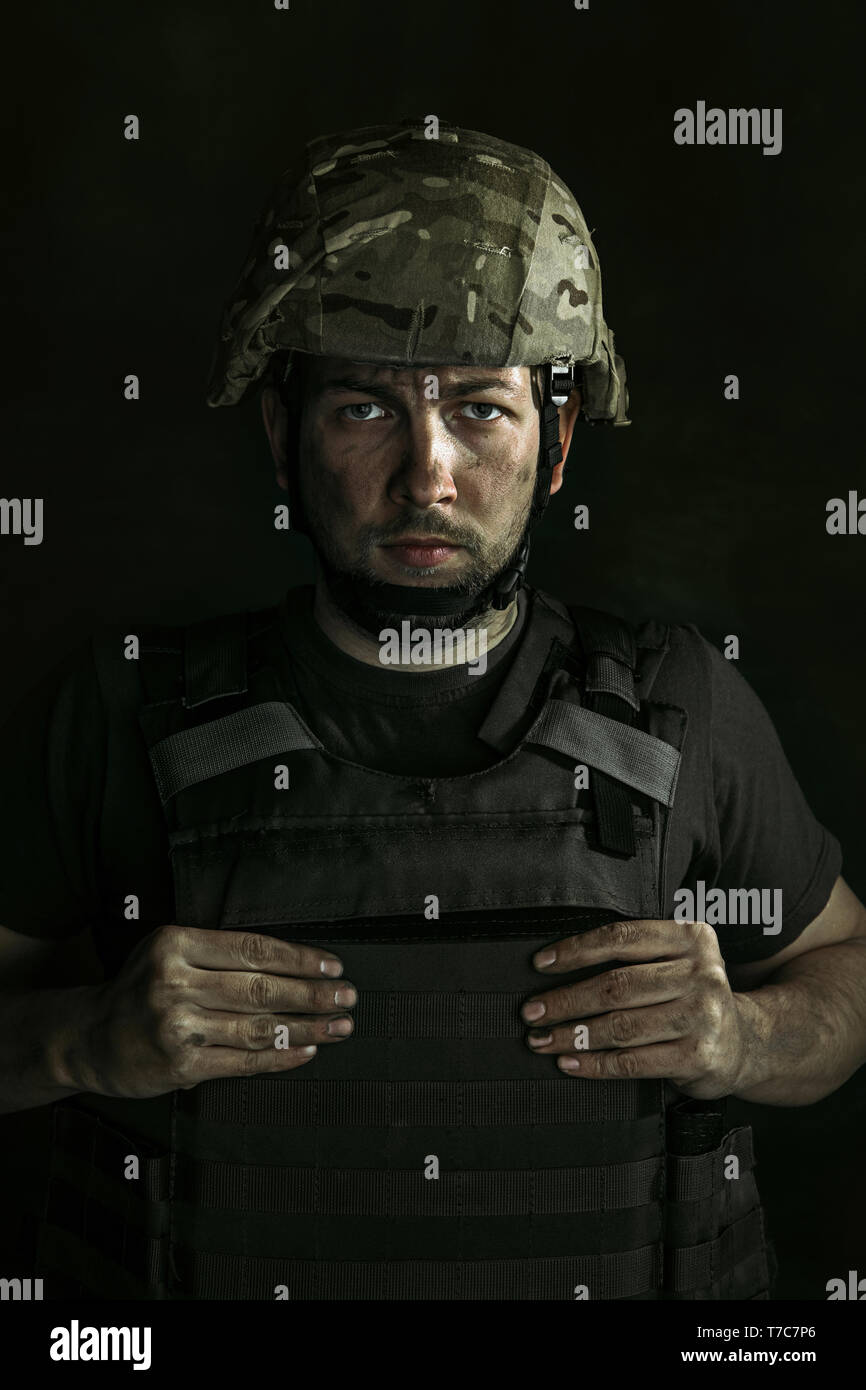 Ready to save their lives. Half-lenght portrait of young male soldier ...
