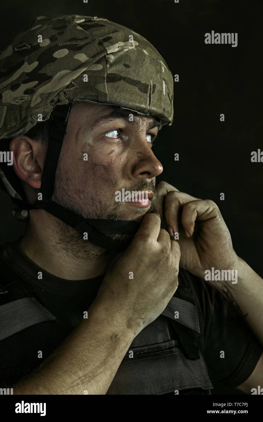 Just want to be alive. Close up portrait of young male soldier. Man in ...