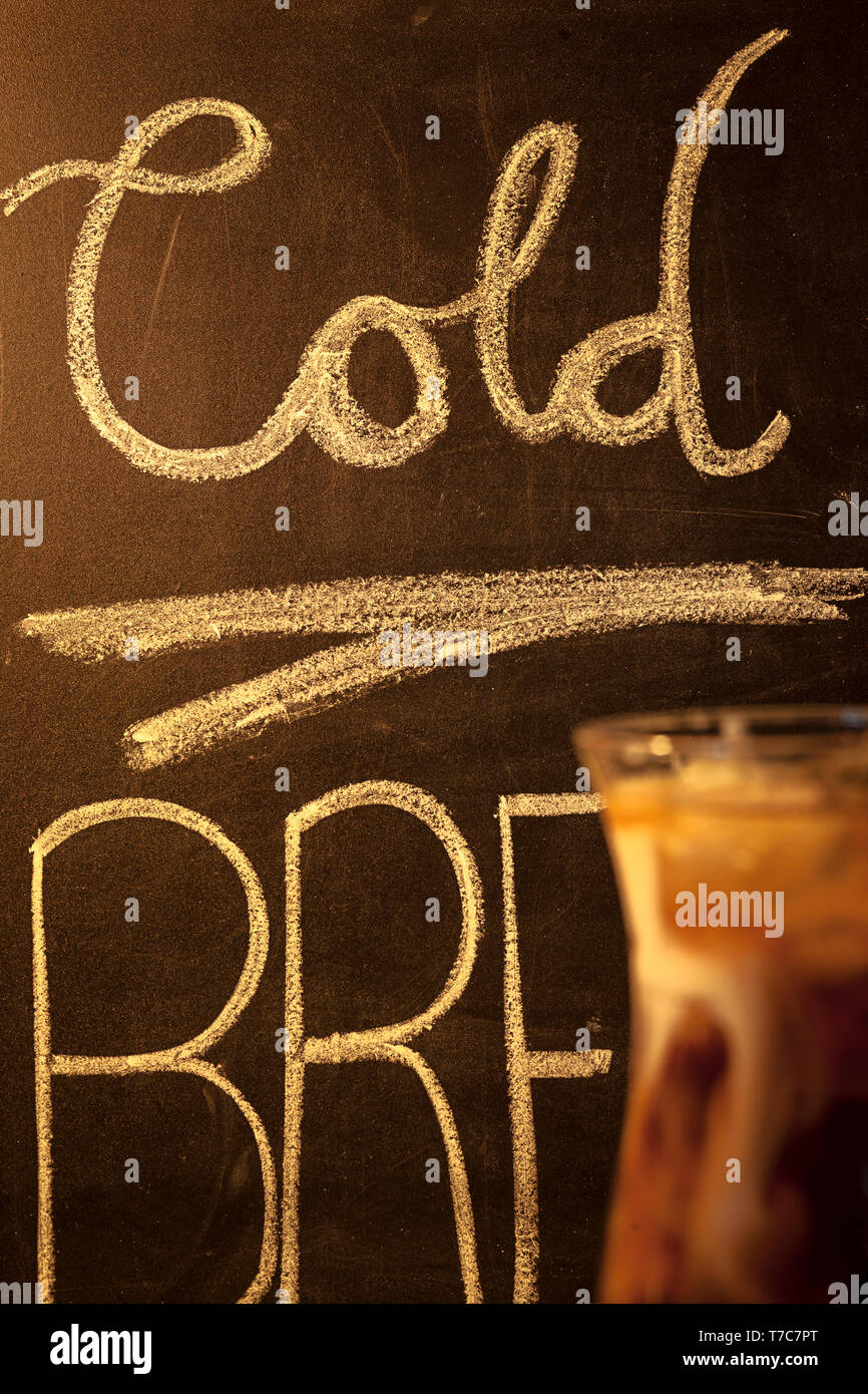 Cold brew coffee with writing on chalk board in background Stock Photo ...