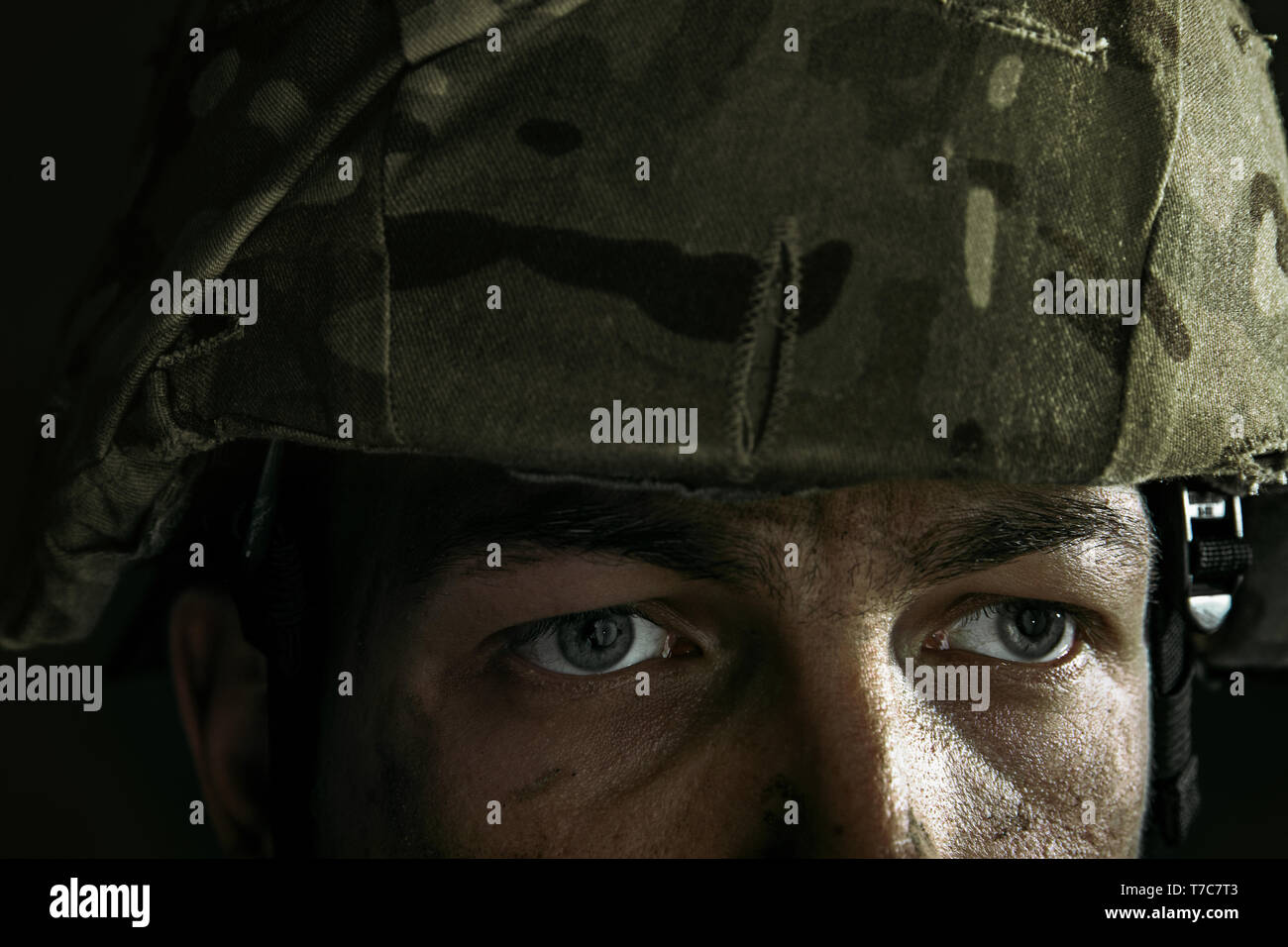 Empty mirrors of bleeding soul. Close up portrait of young male soldier ...