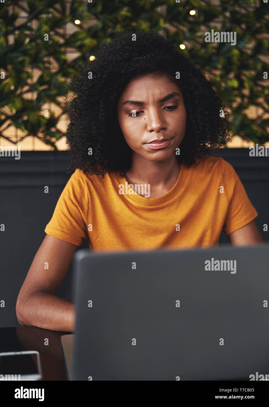 Young serious woman using hi-res stock photography and images - Alamy