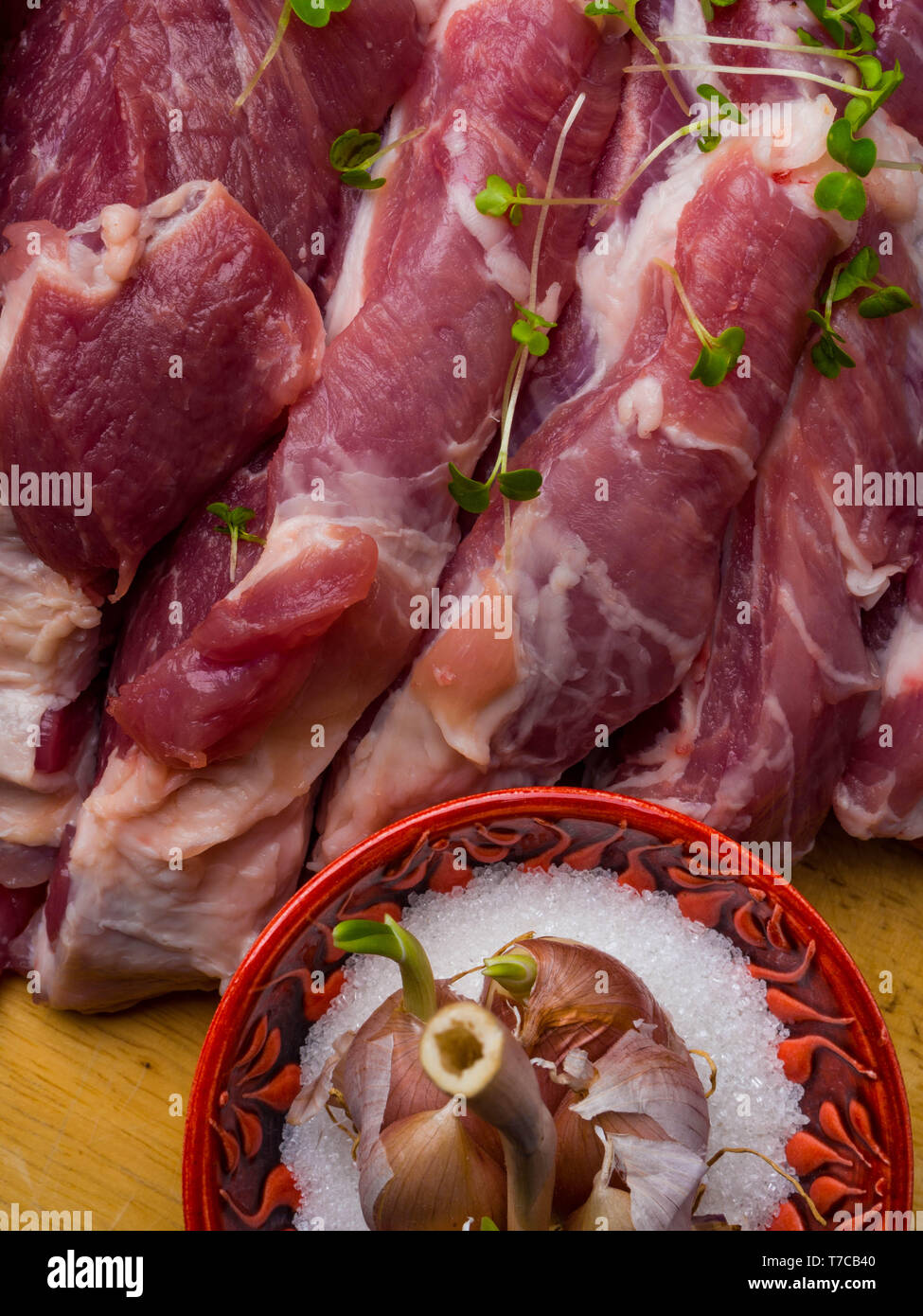 Fresh raw beef meat slices with microgreens background Stock Photo - Alamy