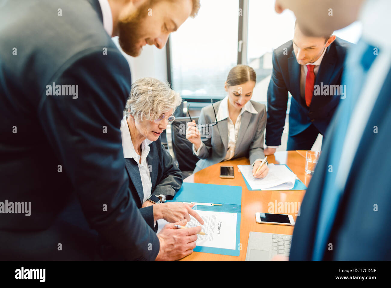 Business people in the office during meeting discussing a transaction ...