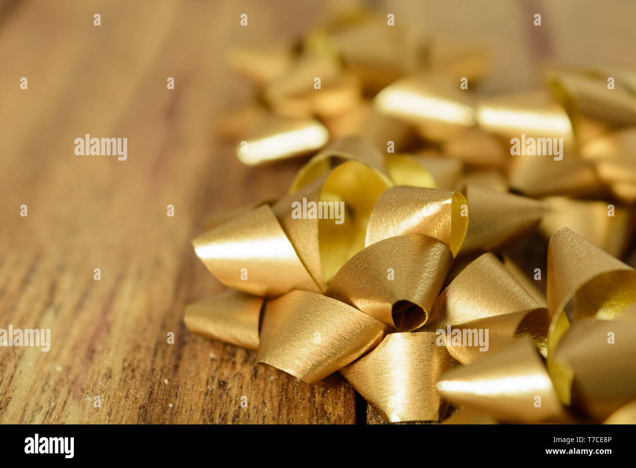 Beige bows over brown wooden background Stock Photo - Alamy