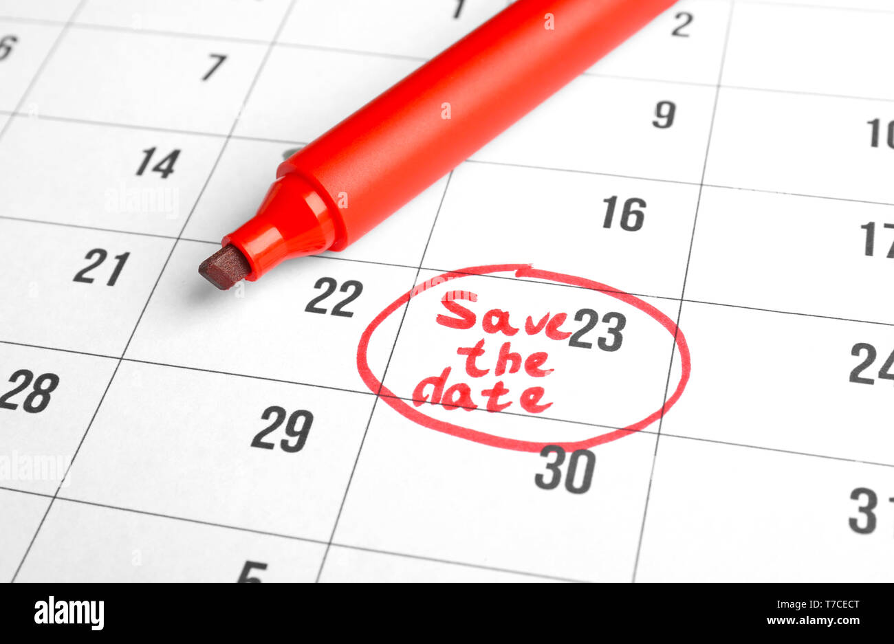 Red marker and phrase "Save the Date" written on calendar, closeup ...