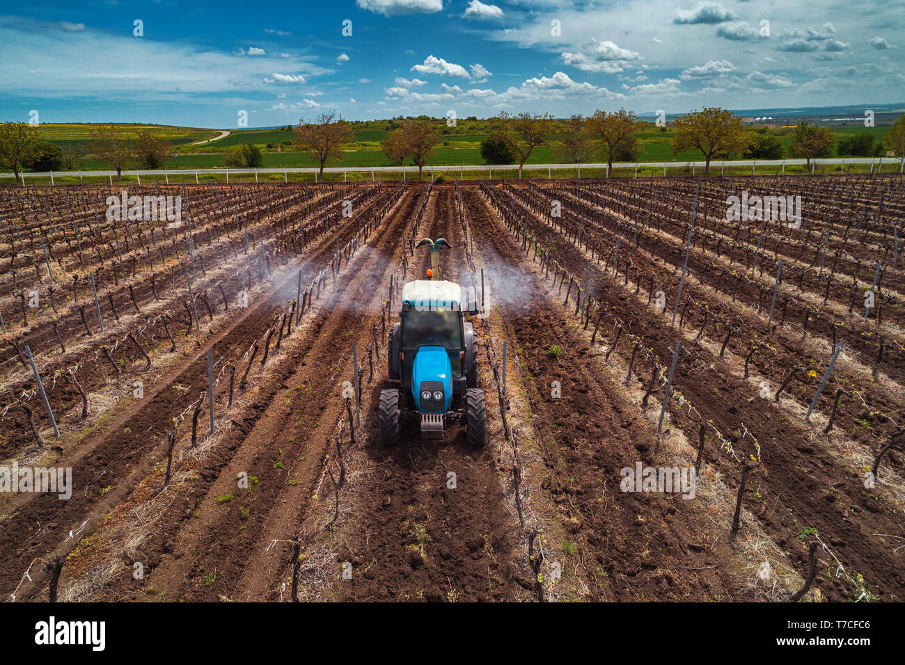 Aerial view of tractor spraying vineyard with fungicide Stock Photo - Alamy