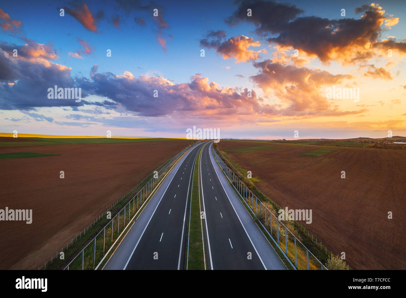 Aerial view of highway on sunset. Transportation background. Landscape ...