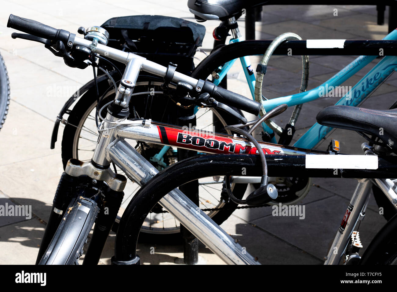 Bicycles chained to bike parking rack located in City centre shopping ...