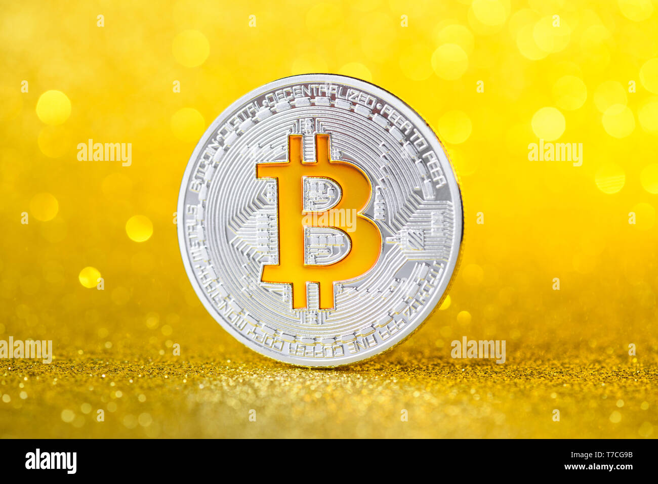 Shiny silver bitcoin coin. Golden bitcoin symbol on golden shiny ...