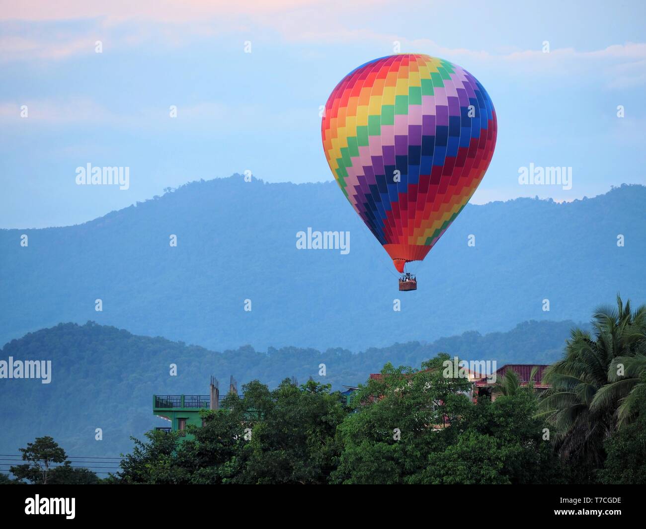 Colorful hot-air balloon rising just in time to explore the beautiful ...